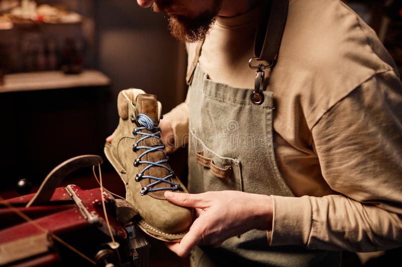 Young Shoemaking Master Sewing Upper Part of Boot Workpiece Together ...