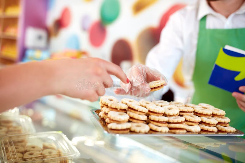 Young Shopkeeper at Work Selling Sweets To Customer Stock Image - Image ...