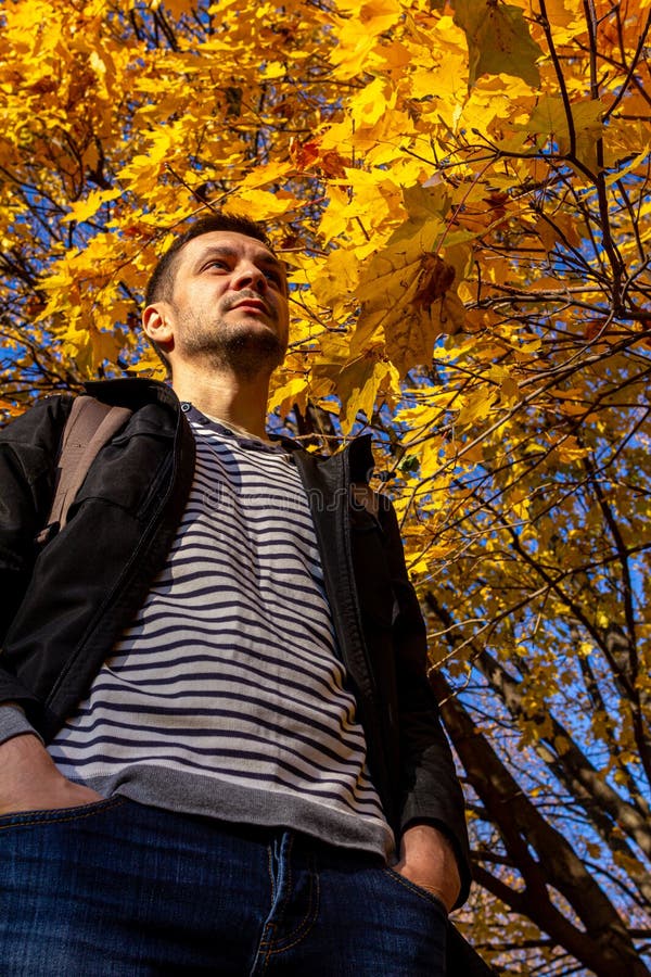 A Young Short-haired Guy Wearing a Black Jacket Standing Under the ...