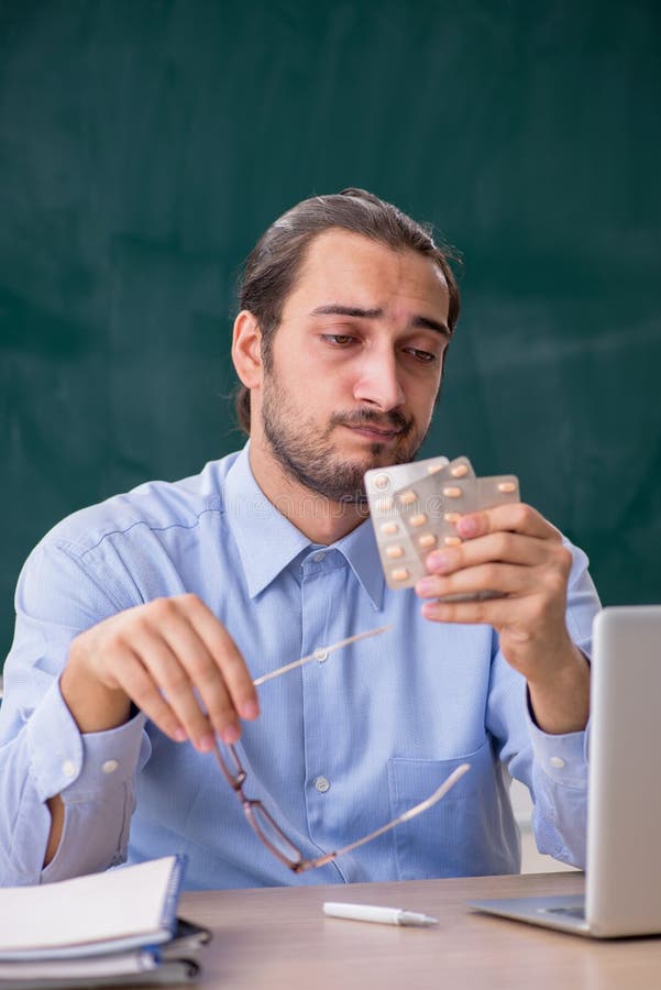 Young Sick Male Teacher in the Classroom Stock Image - Image of class ...