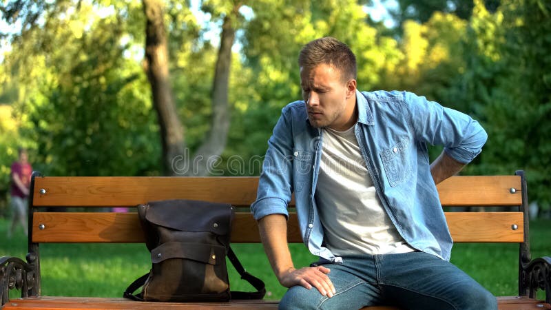Young Sick Man Feeling Back Ache Sitting Bench, Disk Herniation, Spinal ...