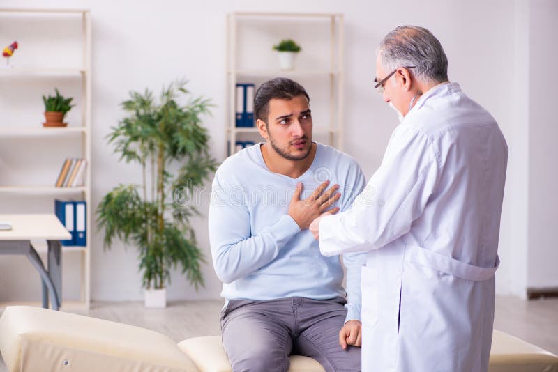 Young Sick Man Visiting Old Doctor Stock Image - Image of examination ...