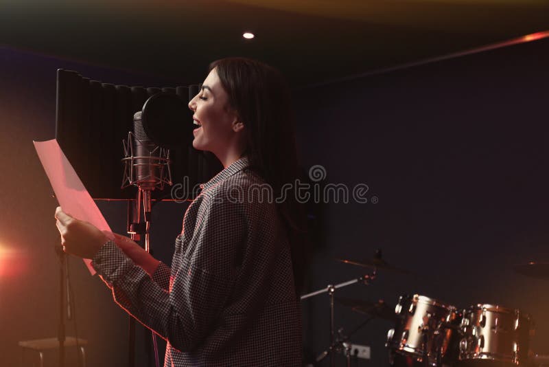 Young Singer with Microphone Recording Song in Studio Stock Photo ...