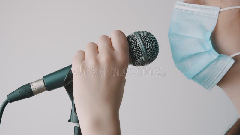 Young Singer Singing in the Microphone with Face Mask in Home Studio ...