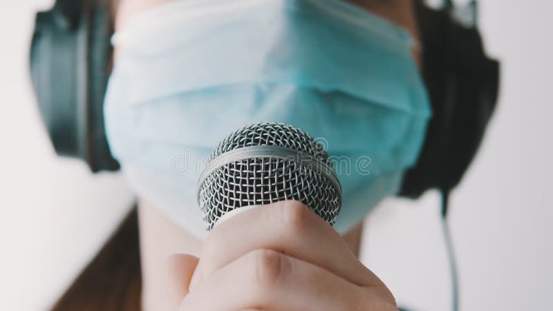 Young Singer Singing in the Microphone with Face Mask in Home Studio ...