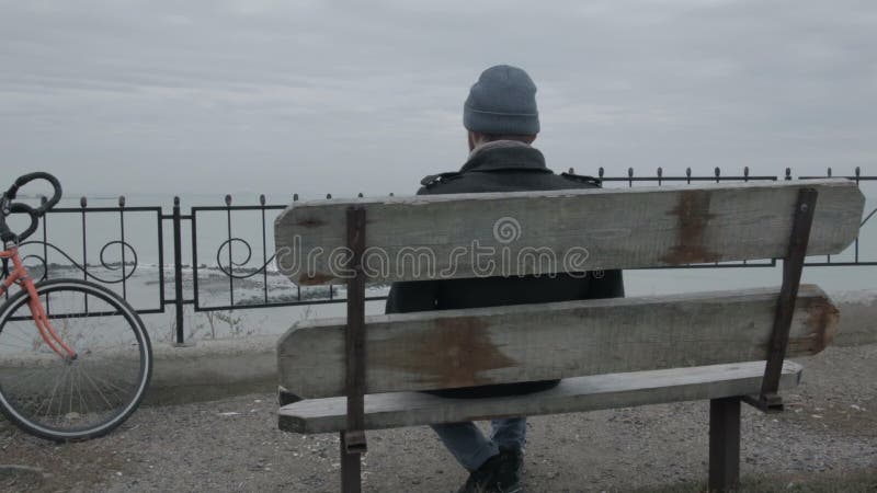 A Young Single Guy Sitting on a Bench Stock Footage - Video of single ...
