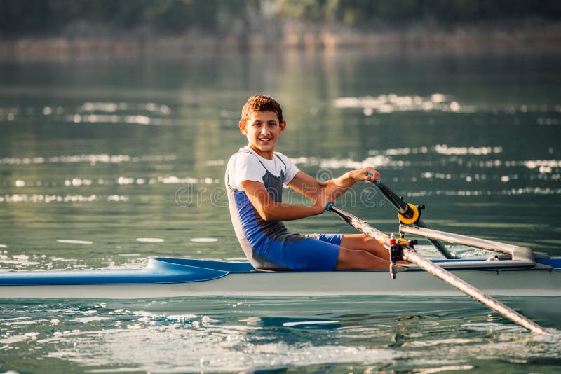 A Young Single Scull Rowing Competitor Paddles on the Tranquil Lake ...