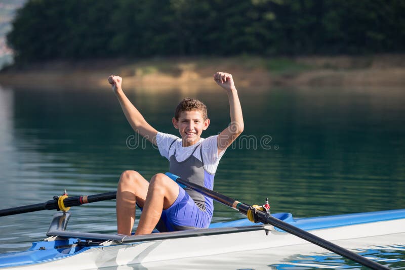 A Young Single Scull Rowing Competitor Paddles on the Tranquil Lake ...