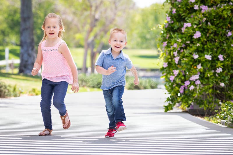 Young Sister and Brother Running at the Park Stock Photo - Image of ...