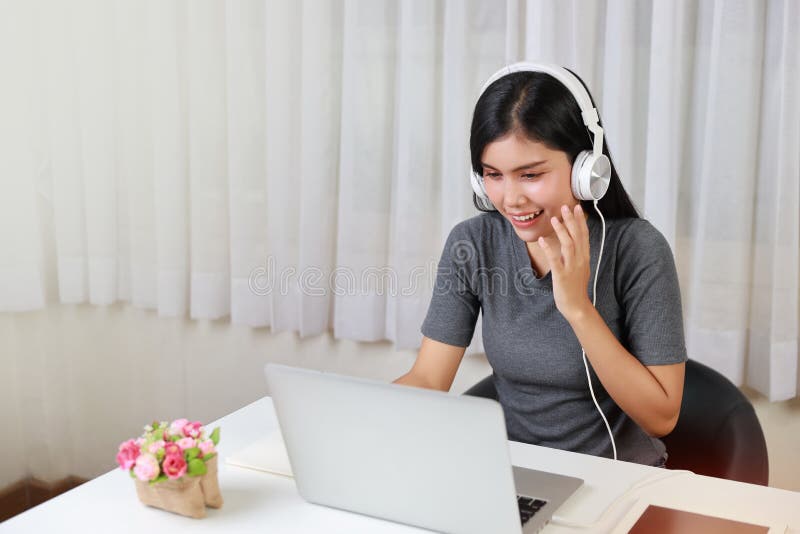 Young Smart and Active Asian Female Student Sitting at Table with ...