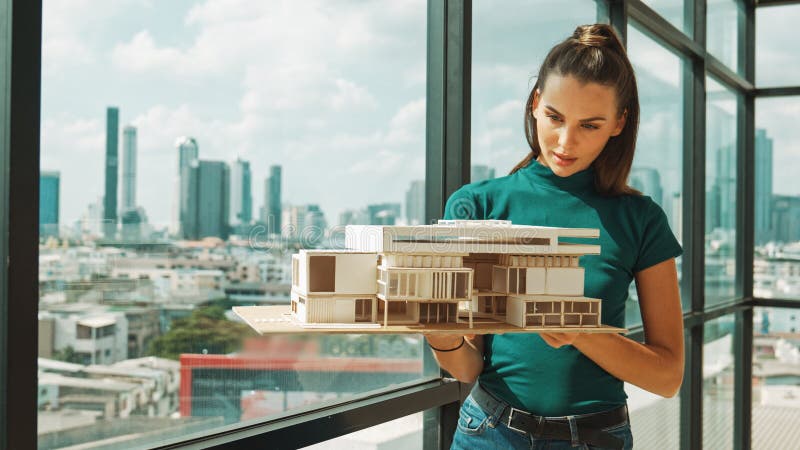 Young Engineer Hold Architectural Model while Inspect House Model ...