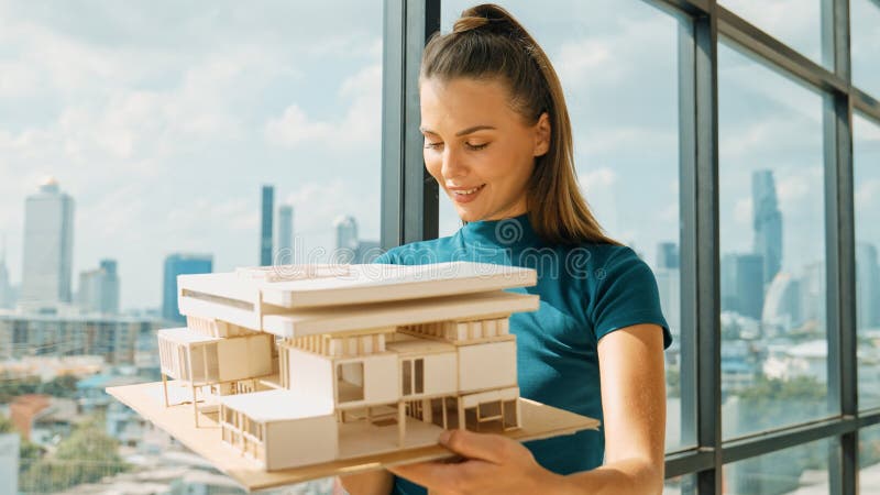 Young Engineer Hold Architectural Model while Inspect House Model ...