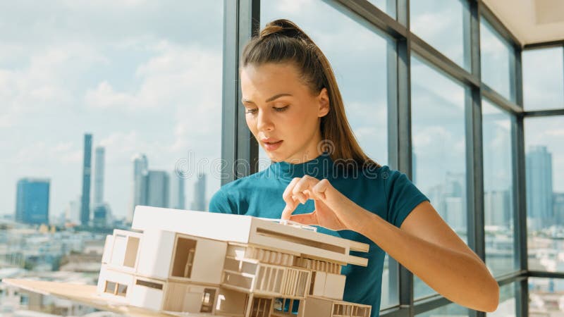 Young Engineer Hold Architectural Model while Inspect House Model ...