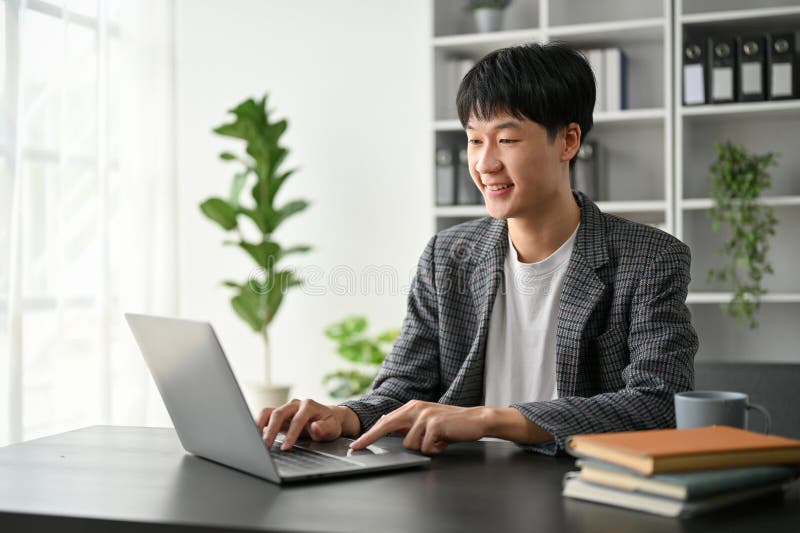 Young Smart Businessman Working on Laptop while Sitting at the Office ...