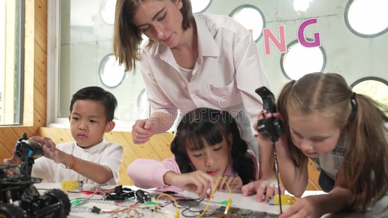 Young Smart Teacher Teaching Diverse Students about Electronic Board ...