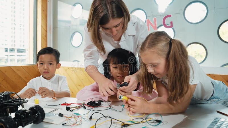 Young Smart Teacher Teaching Diverse Students about Electronic Board ...