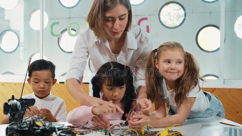 Young Smart Teacher Teaching Diverse Students about Electronic Board ...