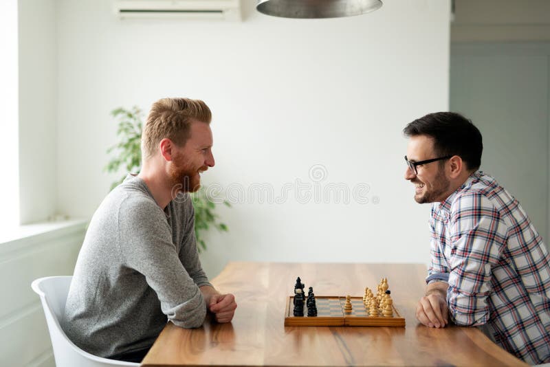 Young Smart Friends Playing Chess at Home Stock Photo - Image of male ...