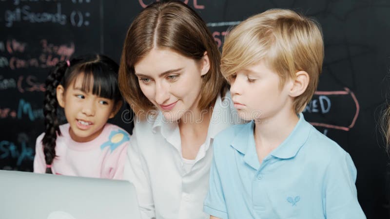 Smart Teacher Teaching and Looking Student Using Laptop at Classroom ...