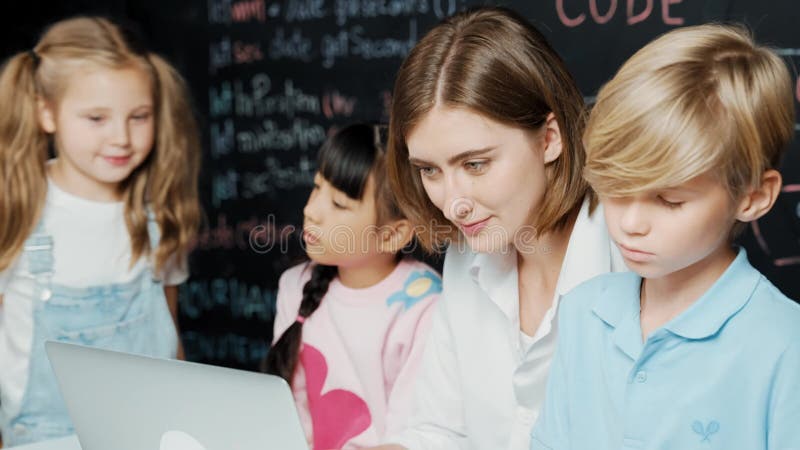 Smart Teacher Teaching and Looking Student Using Laptop at Classroom ...