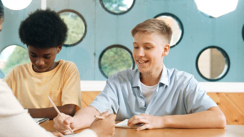 Young Smart Teenager Writing and Talking about Topic at Classroom ...