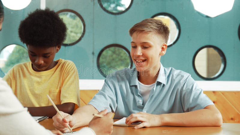 Young Smart Teenager Writing and Talking about Topic at Classroom ...