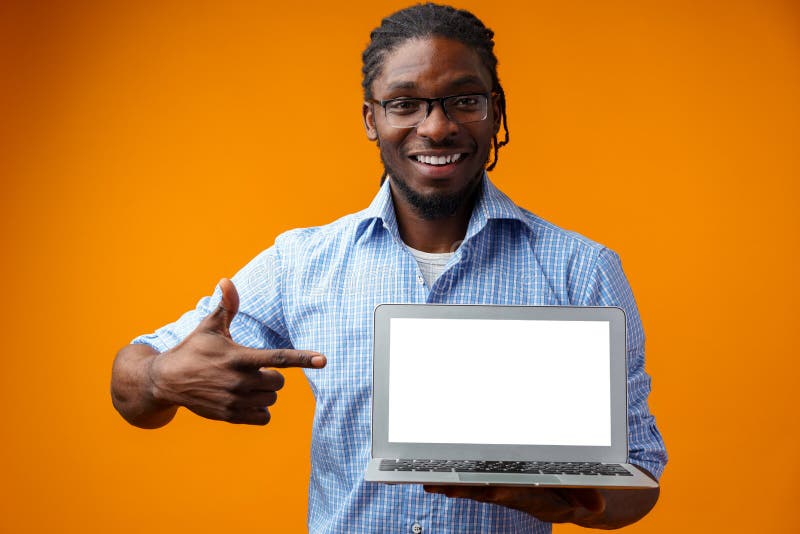 Young Smiling African Man Standing and Using Laptop Computer Over ...