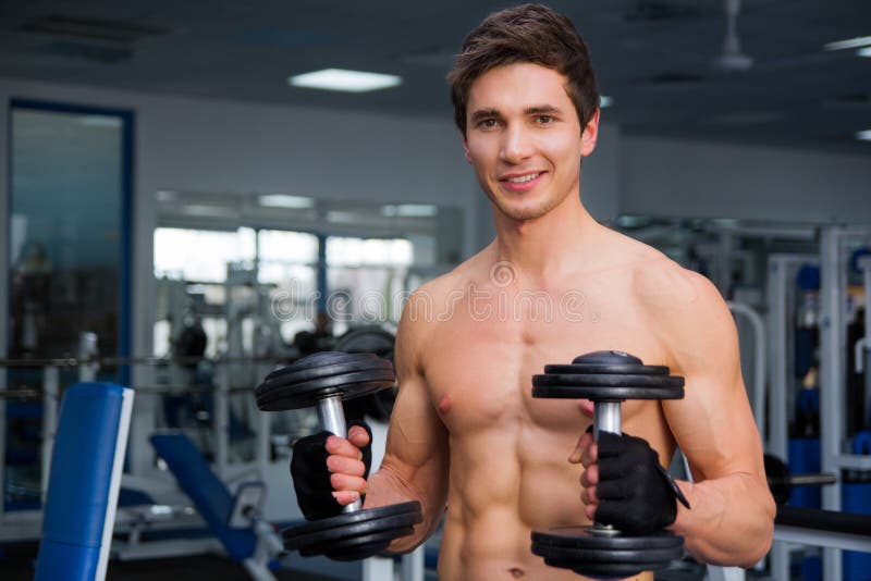 Young Smiling Athlete Lifting Weights in the Gym Stock Photo - Image of ...