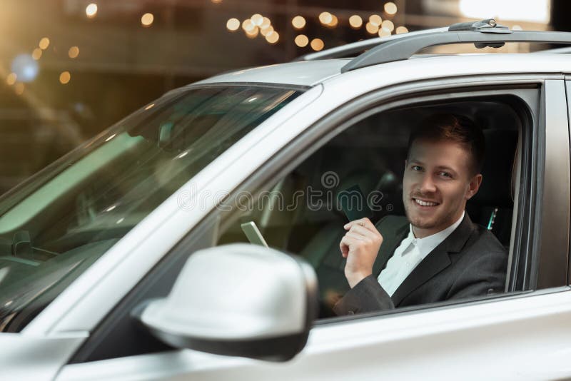 Young Smiling Businessman Looks Happy while Driving His Car with Open ...
