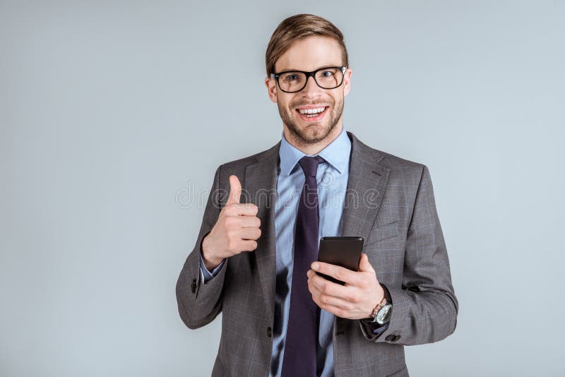 Young Smiling Businessman Using Smartphone and Showing Thumb Up Stock ...