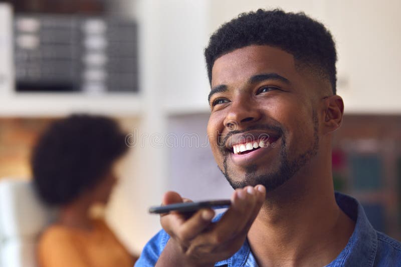 Young Smiling Businessman Working at Desk in Office Talking into Mic of ...