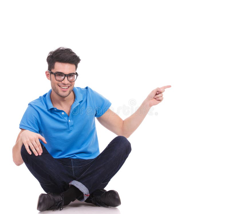 Young Smiling Casual Man Sitting And Pointing To Side Stock Image ... Young Smiling Casual Man Sitting And Pointing To Side Stock Image ...