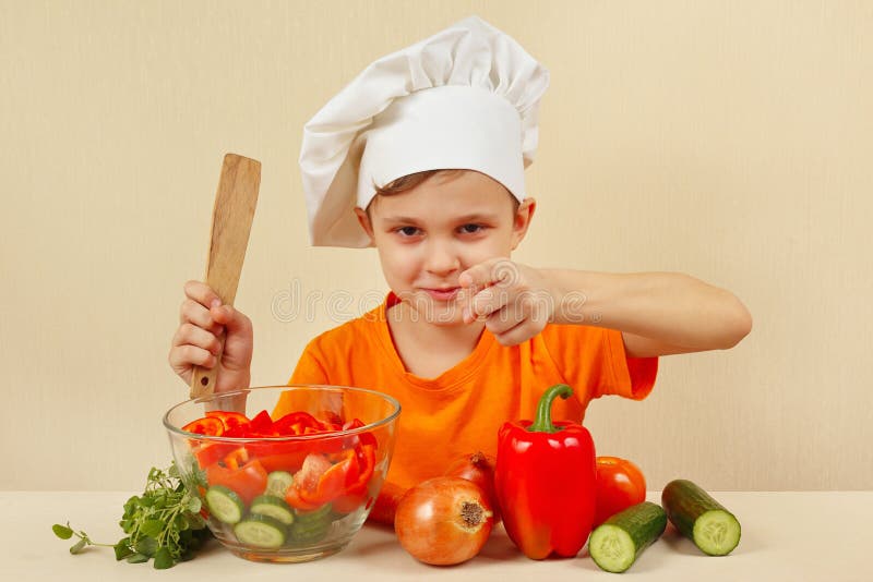 Young Smiling Chef Shows How To Cook Vegetable Salad Stock Photo ...