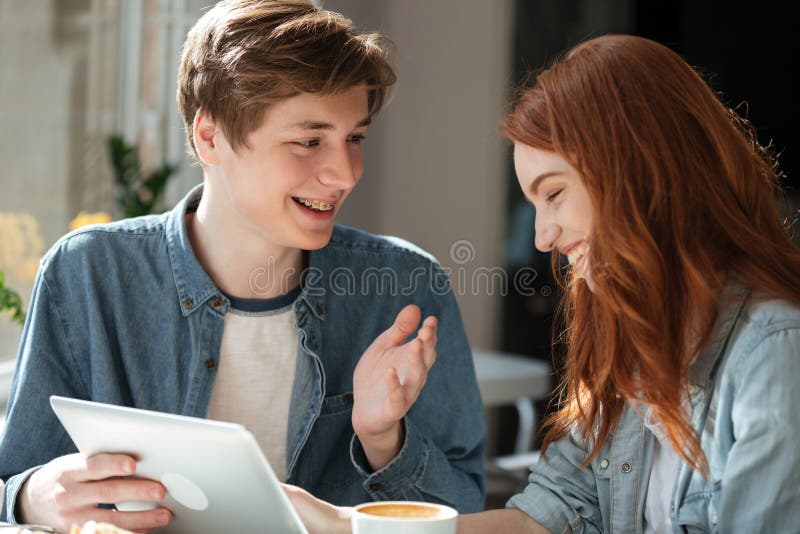 Young Smiling Couple Talking while Using Tablet Stock Photo - Image of ...
