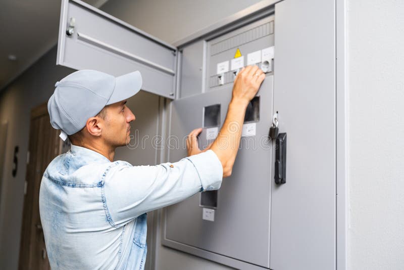 Young Smiling Electrician Doing His Work, Electrical Panel Stock Image ...