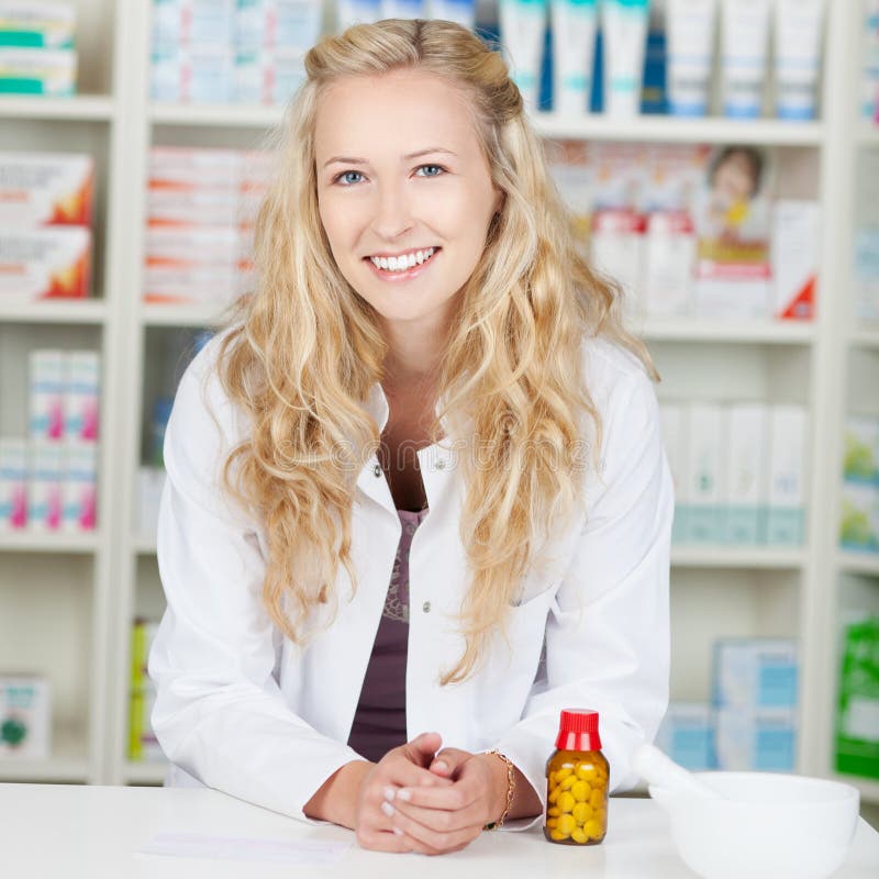 Young Smiling Female Pharmacist Stock Image - Image of medicine ...