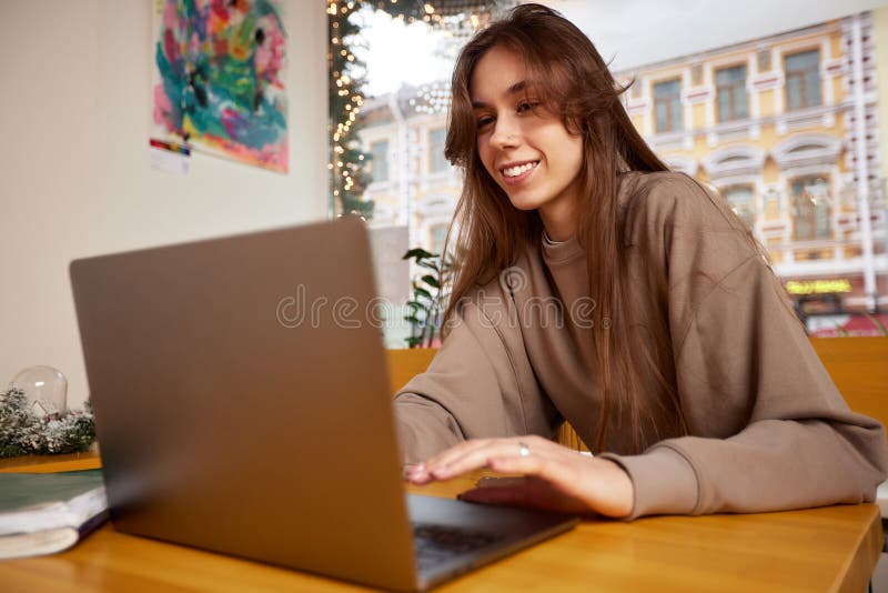Young Smiling Female Student Using Laptop for E-learning in Headphones ...
