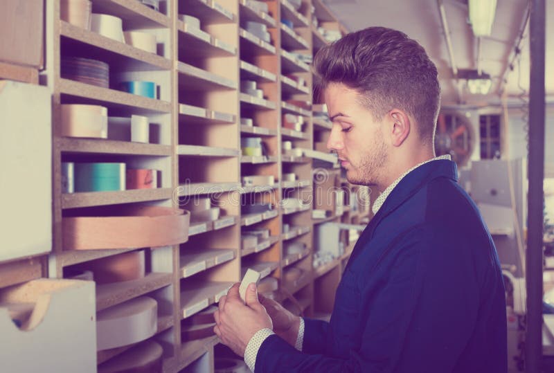 Young Smiling Guy Searching for Items in Storage Stock Photo - Image of ...