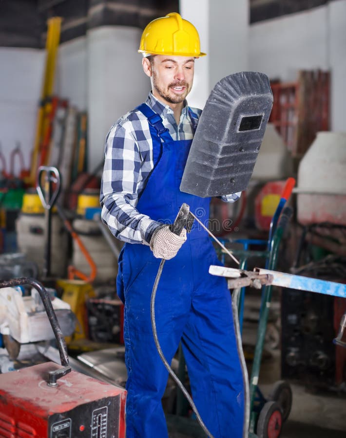 Smiling Guy Using Welder for Construction Work Stock Photo - Image of ...