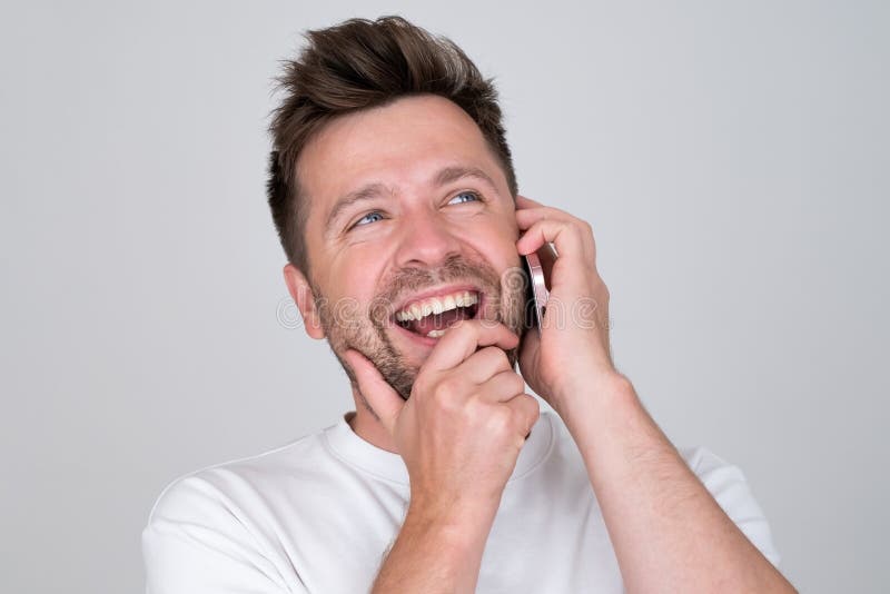 Young Smiling Happy Caucasian Man Talking Speaking by Mobile Cell Phone ... Young Smiling Happy Caucasian Man Talking Speaking by Mobile Cell Phone ...
