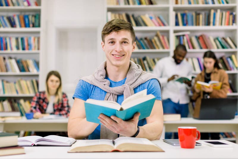 Young Smiling Hipster Student Studying in Library at the University ...