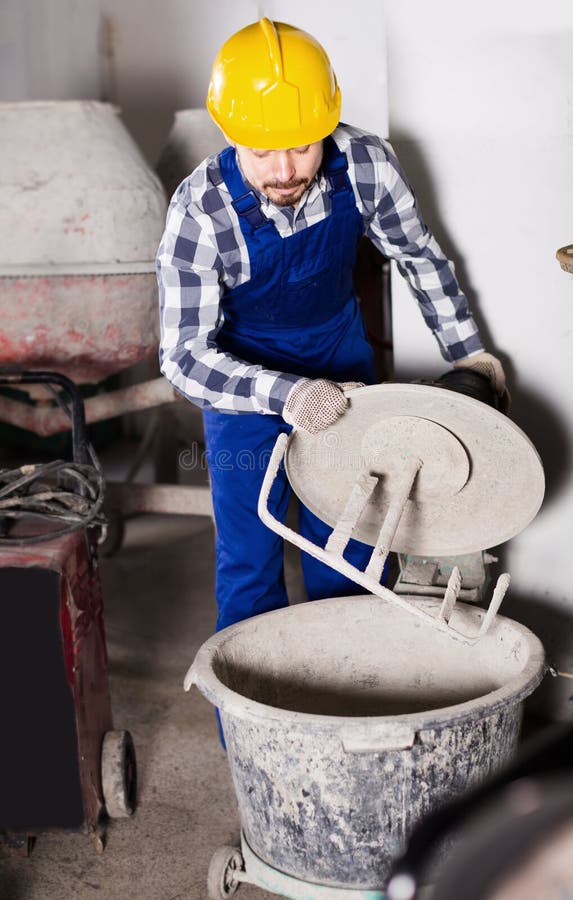 Young Smiling Male Using Concrete Mixer at Workshop Stock Photo - Image ...