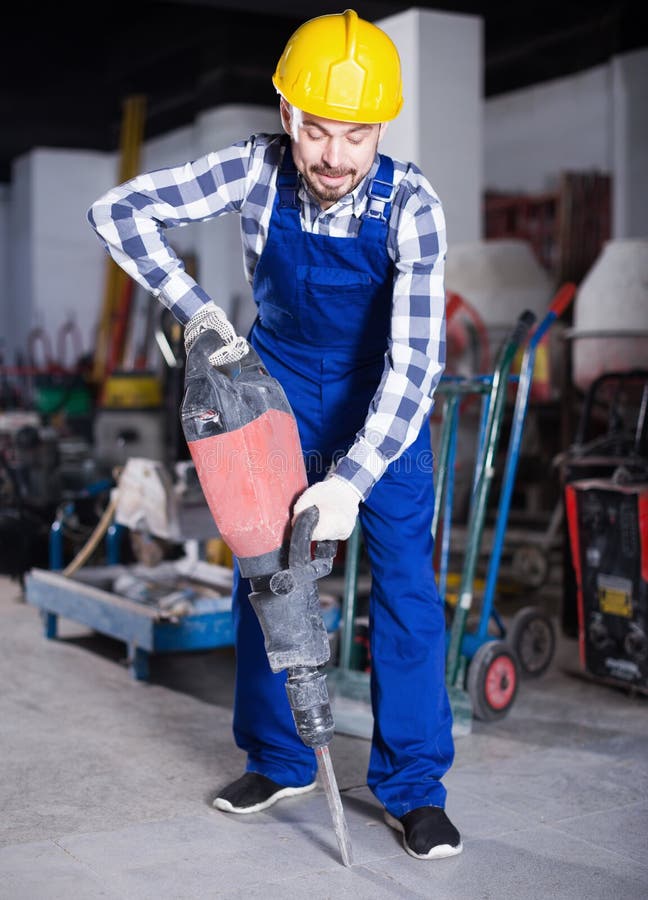 Young Smiling Male Using Jackhammer for Construction Stock Photo ...