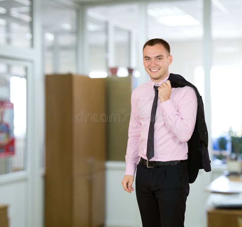 Young Smiling Man in Business Dress Code at Office Interior Stock Photo ...