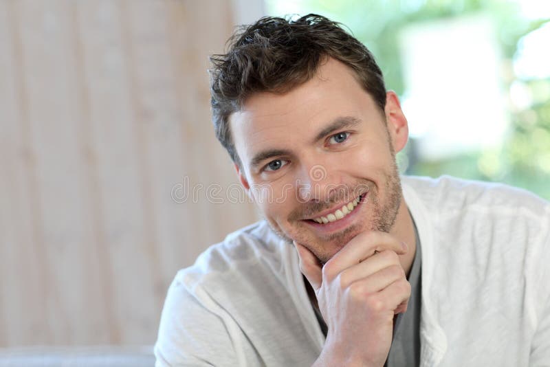 Young smiling man at home stock image. Image of home - 65020191