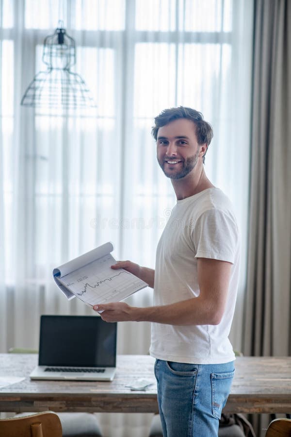 A Young Smiling Man with Project Papers in Hands Stock Photo - Image of ...