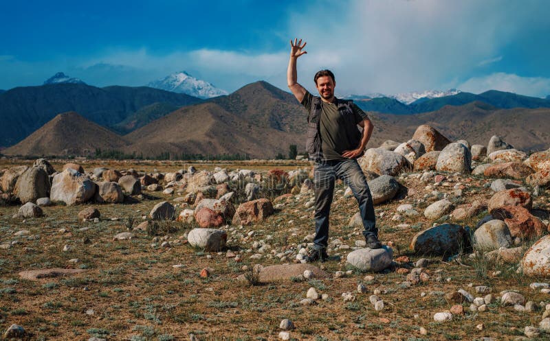 Smiling Man Stands on Mountain and Waving His Hand Stock Image - Image ...