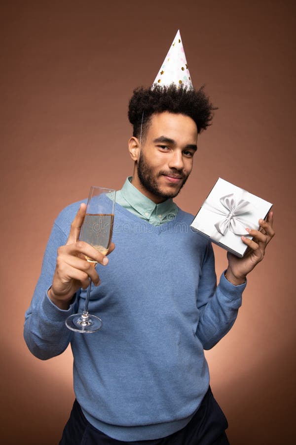 Young Smiling Mixed-race Man Holding Flute of Sparkling Champagne and ... Young Smiling Mixed-race Man Holding Flute of Sparkling Champagne and ...