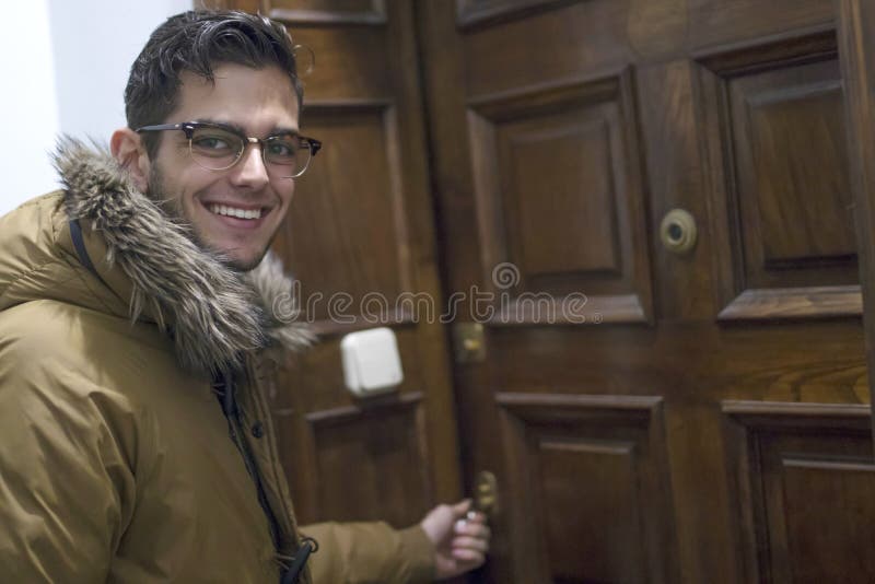 Young Smiling Opening the Door Stock Photo - Image of apartment, people ...