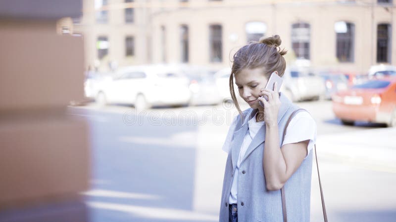 A Young Smiling Pretty Girl is Having a Call Outside Outdoors Stock ...